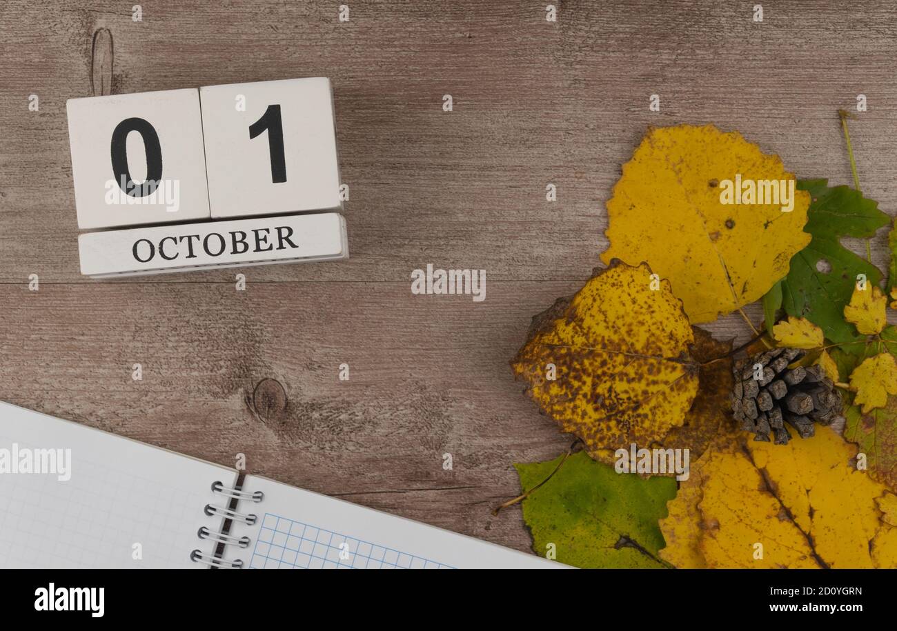 Handmade wood cube with date month and day on a wooden table. 01 ...