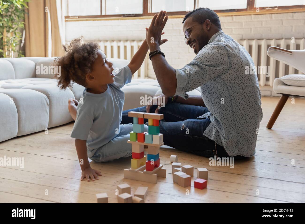Little african american boy giving high five to smiling daddy Stock ...