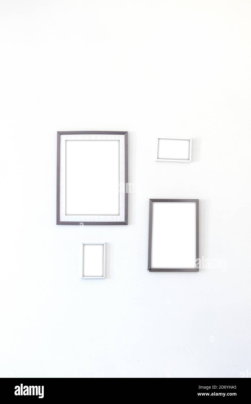 Empty paper frames on a white wall. Interior decor concept. Vertical ...