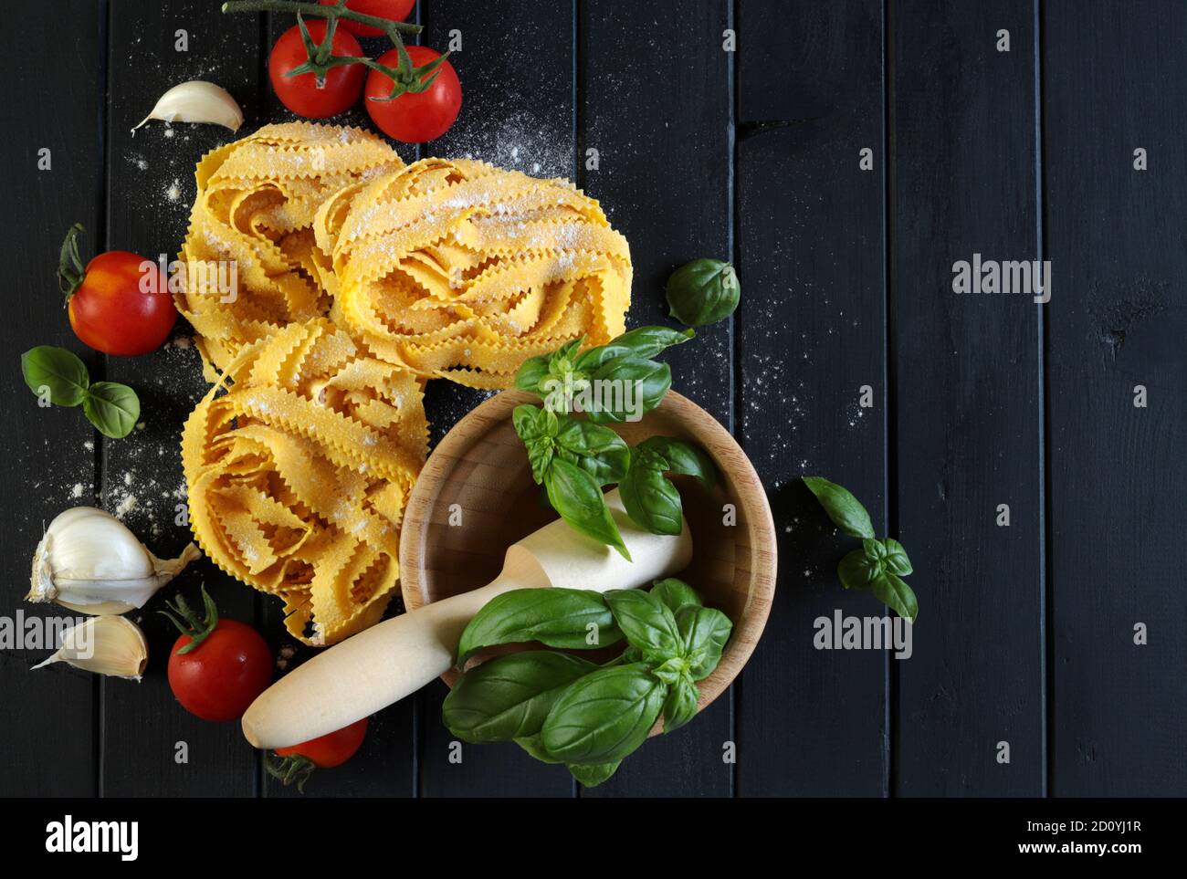 Italian pasta. Curly pappardella pasta, tomatoes, fresh basil and ...
