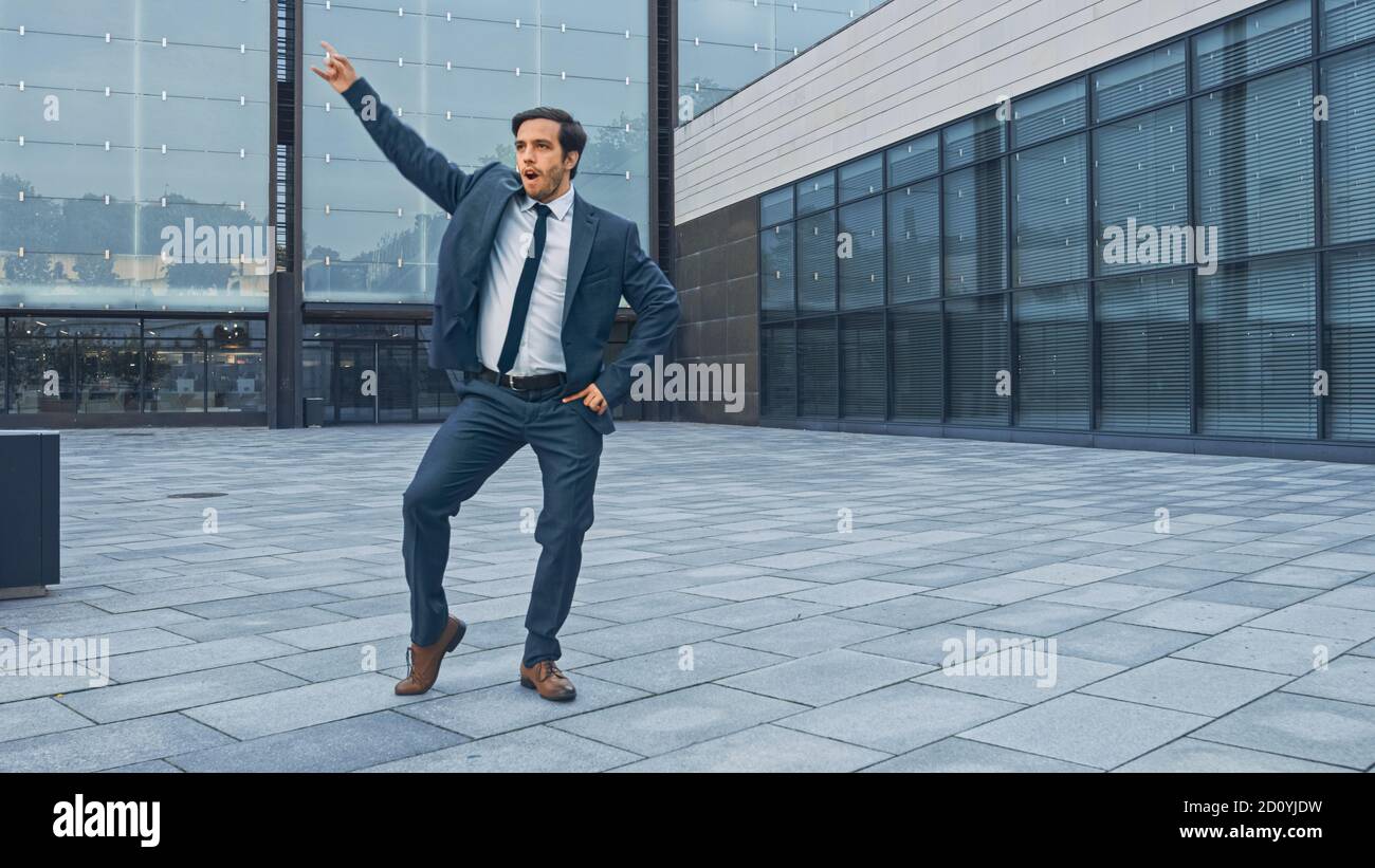 Cheerful and Happy Businessman in a Suit is Actively Dancing on a ...
