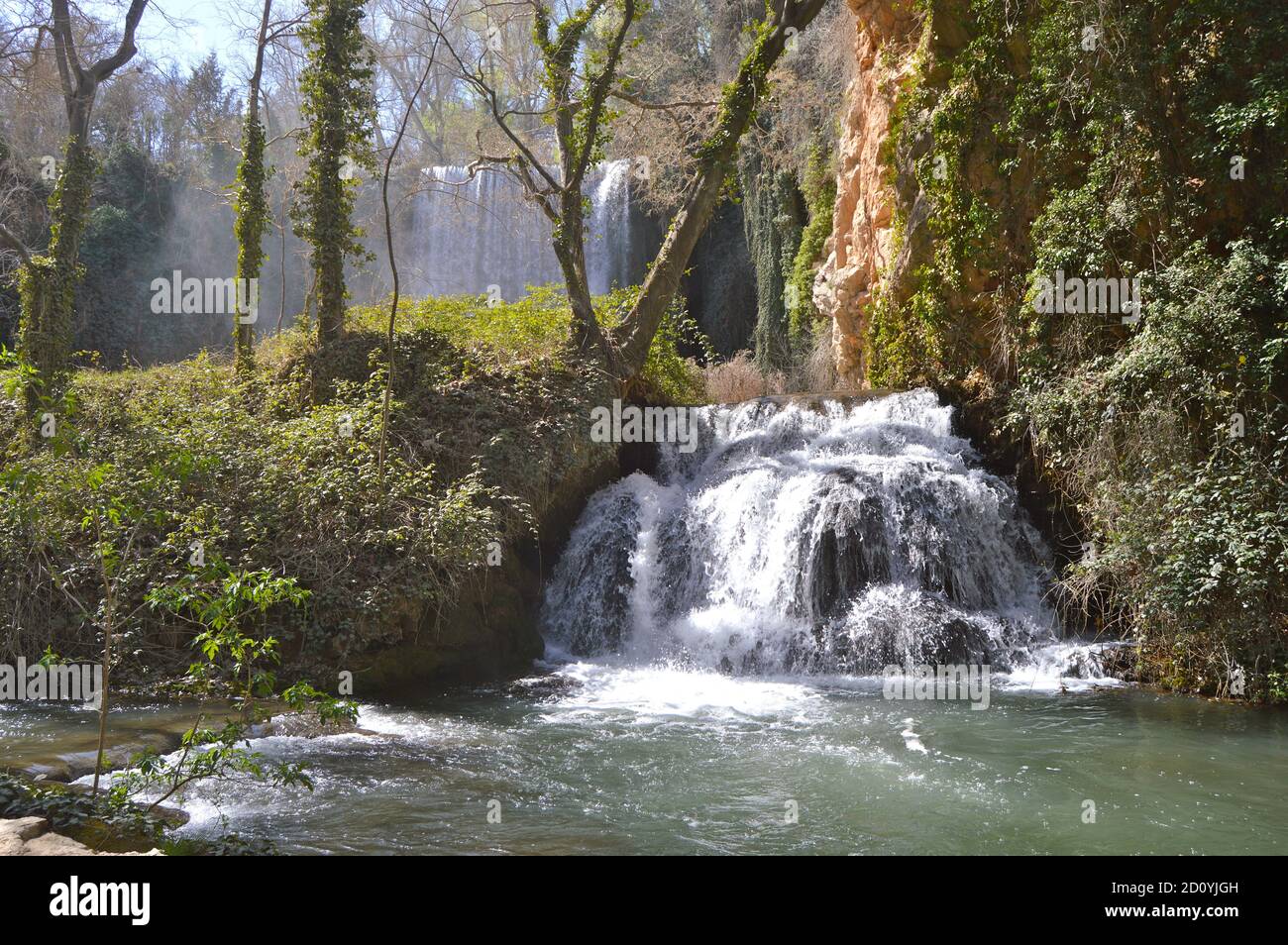 Beautiful low waterfall in a forest at daytime Stock Photo - Alamy