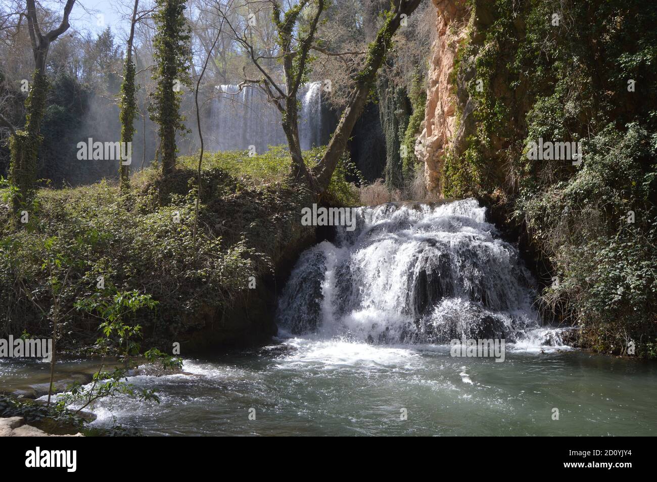 Beautiful low waterfall in a forest at daytime Stock Photo - Alamy