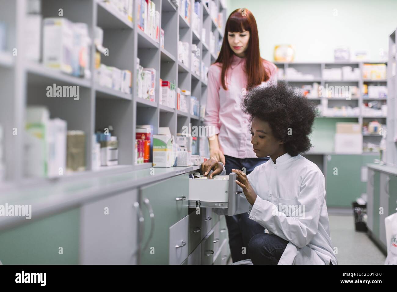 Pretty young smiling woman, buying medicines at the drugstore., while ...