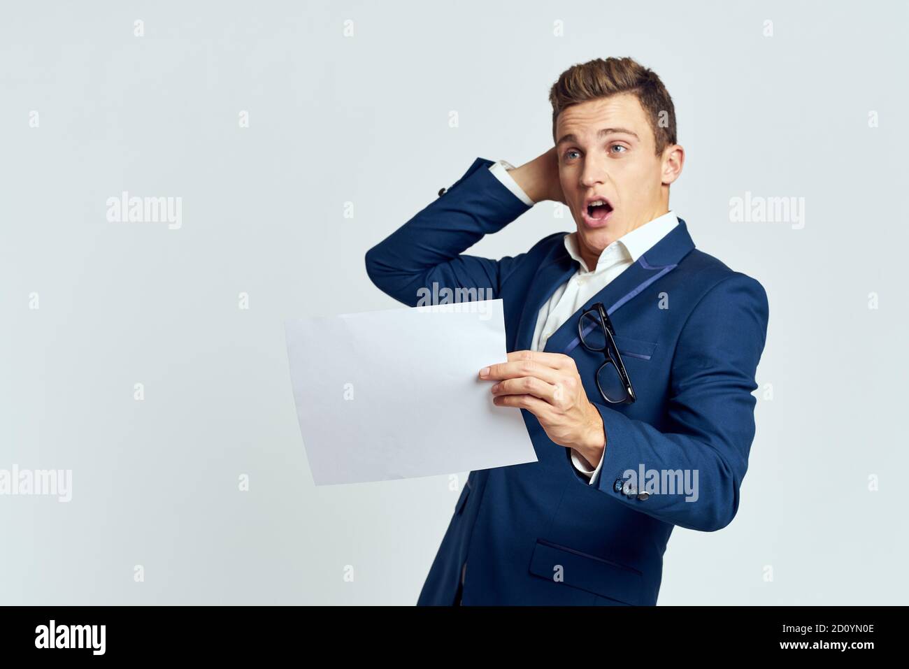 A business man in a suit holds a paper in the hand of an official ...