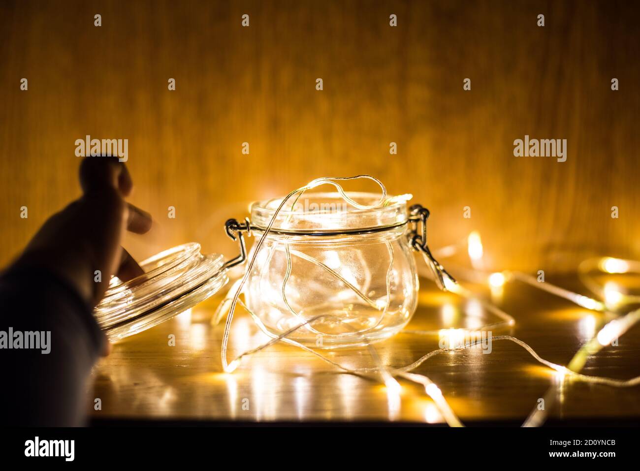 Child opening a jar lid with LED fairy lights Stock Photo - Alamy