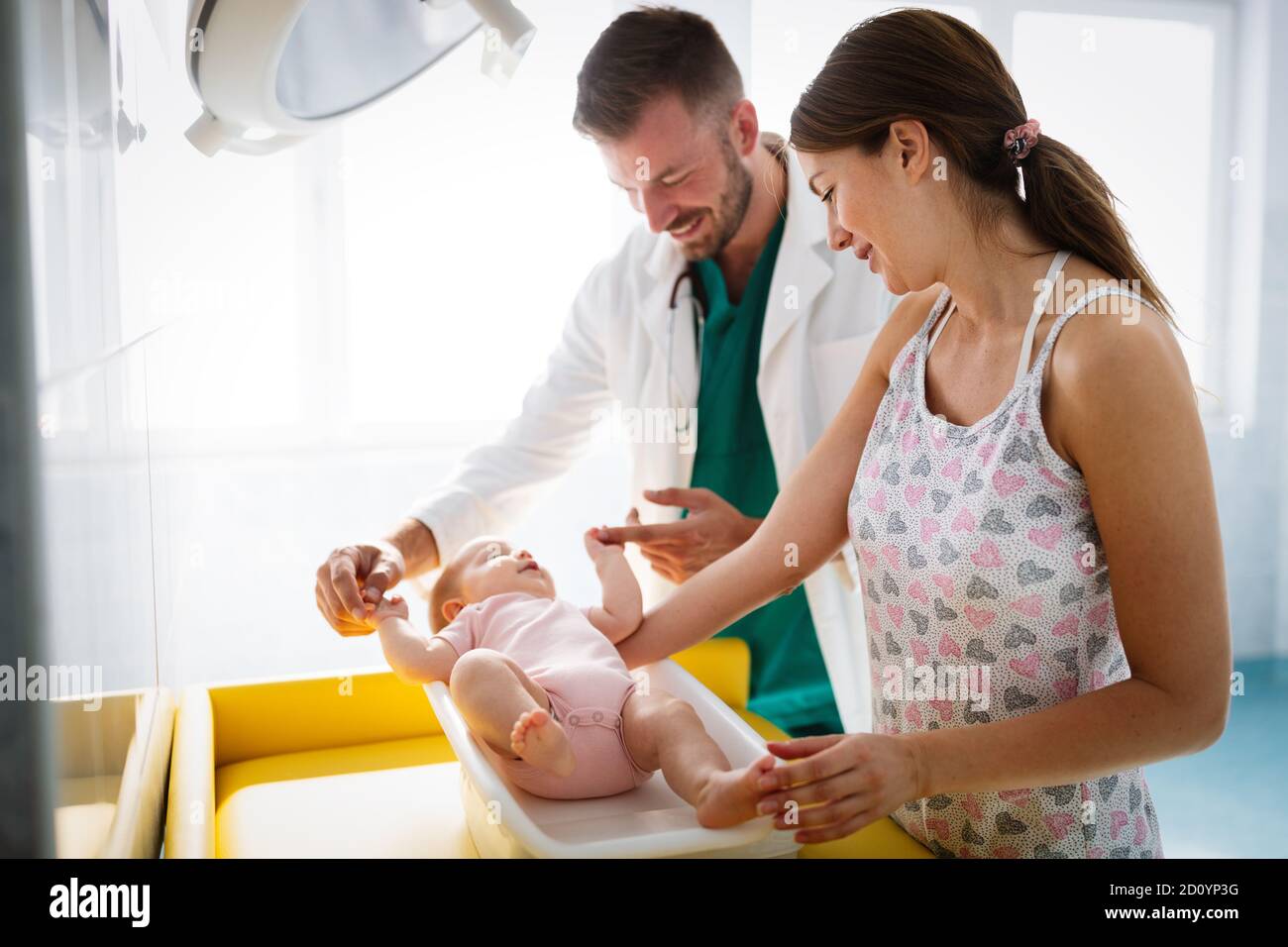 Happy beautiful mother and little baby on medical examination in ...