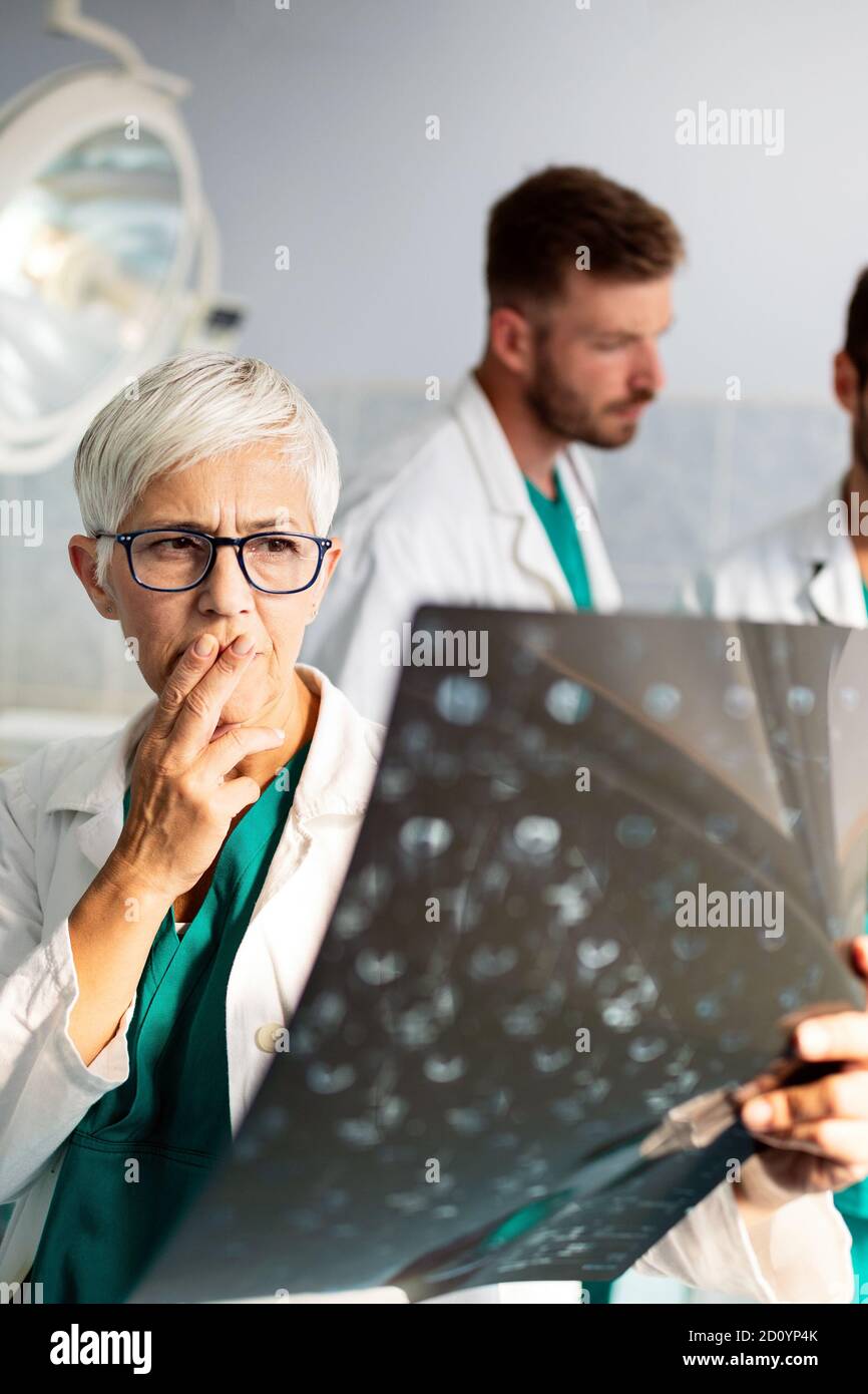 Group of doctors examining an x-ray in hospital to make diagnosis Stock ...