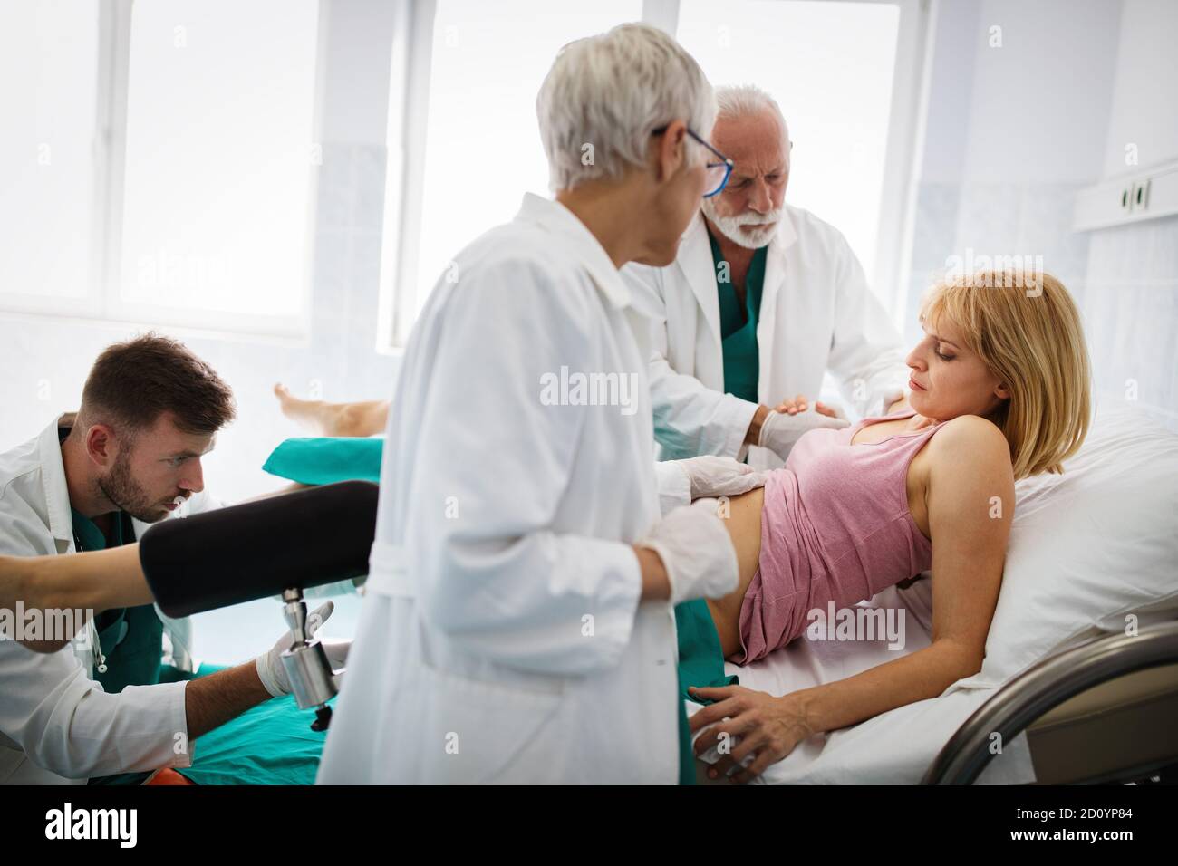 In the hospital woman in labor pushes to give birth, obstetricians ...