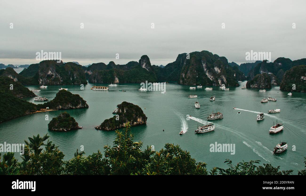 Chaotic landscape of Halong Bay with blue green water and boats Stock ...