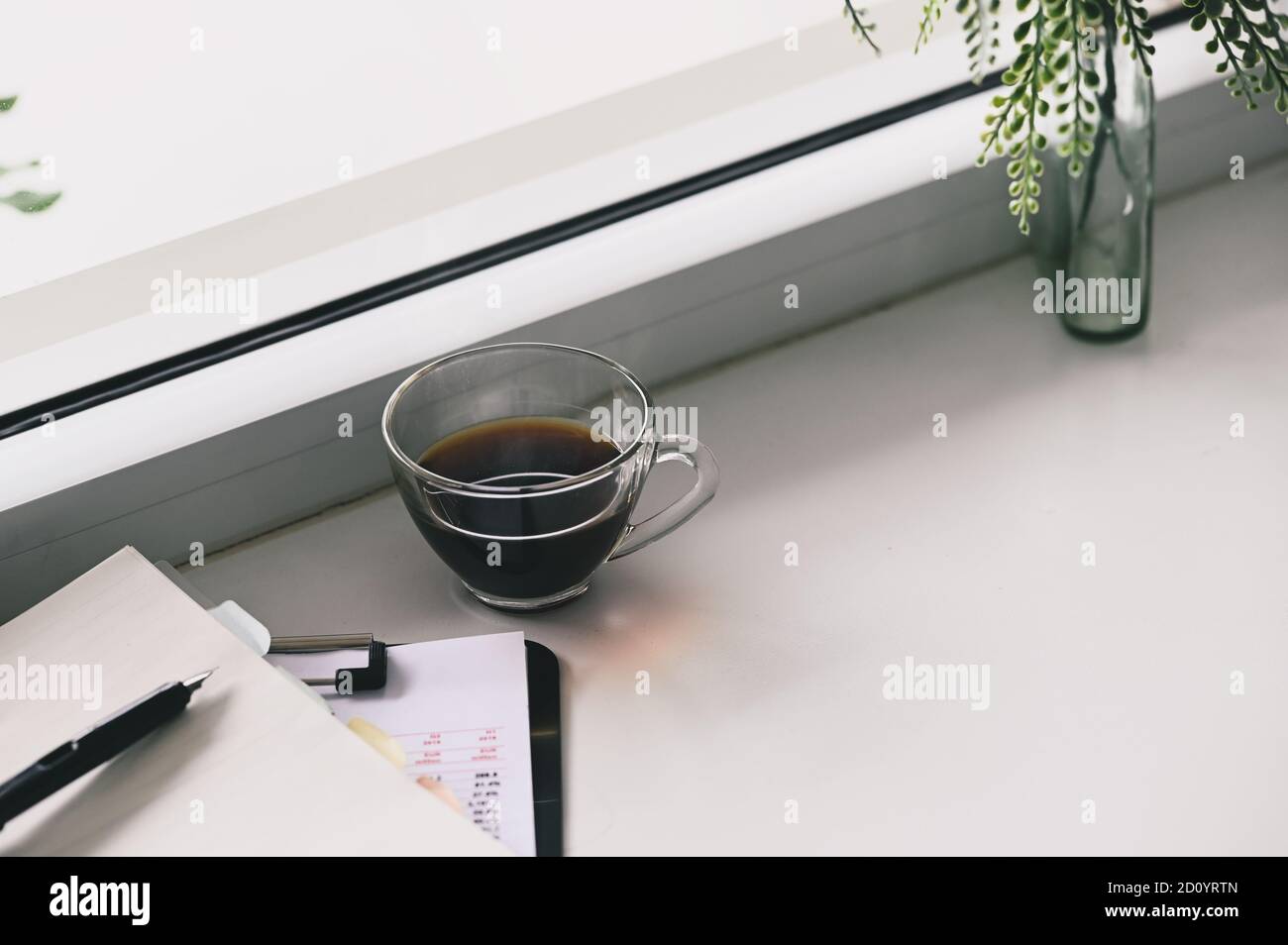 Coffee on work table with business chart Stock Photo - Alamy