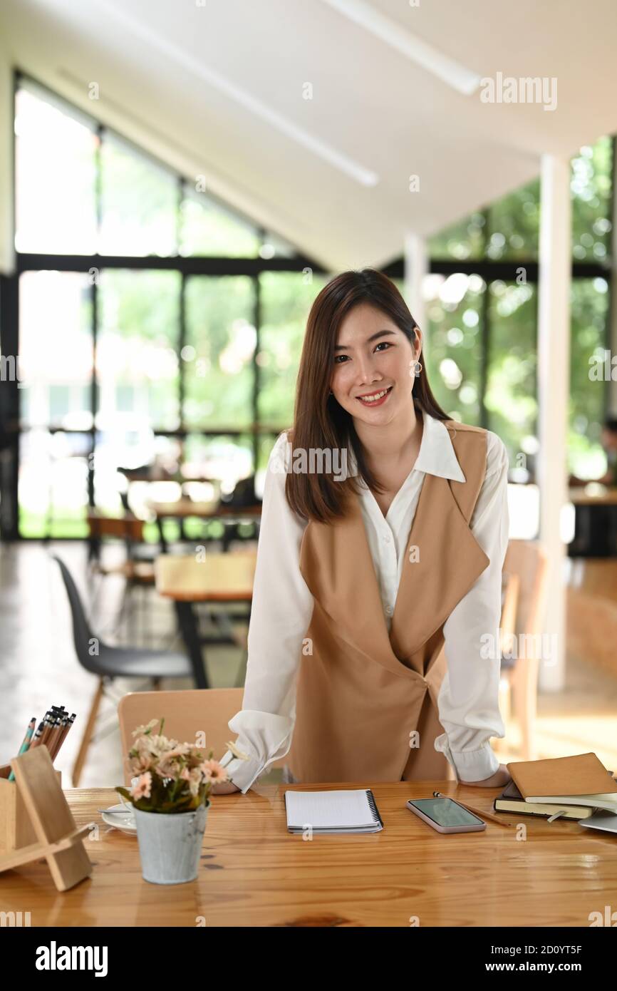 Secretary woman standing on her office desk and smile on face Stock ...