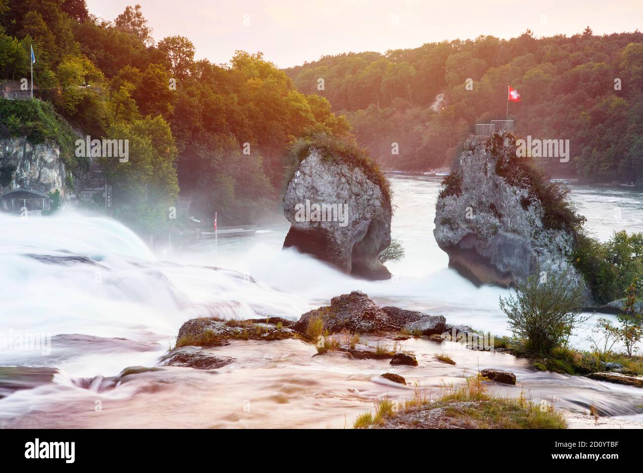 Biggest waterfalls in Europe by sunset. Rhine Falls. Rocks over the ...