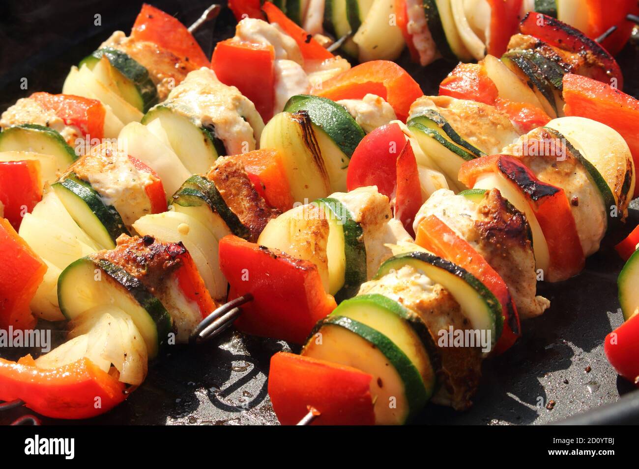 delicious shish kebab skewers in the pan with peppers and onions Stock ...
