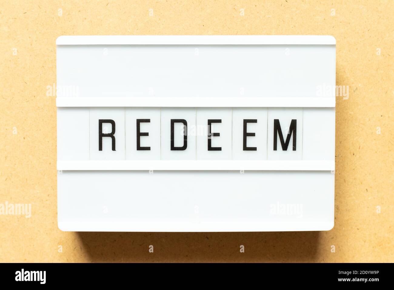 Lightbox with word redeem on wood background Stock Photo - Alamy