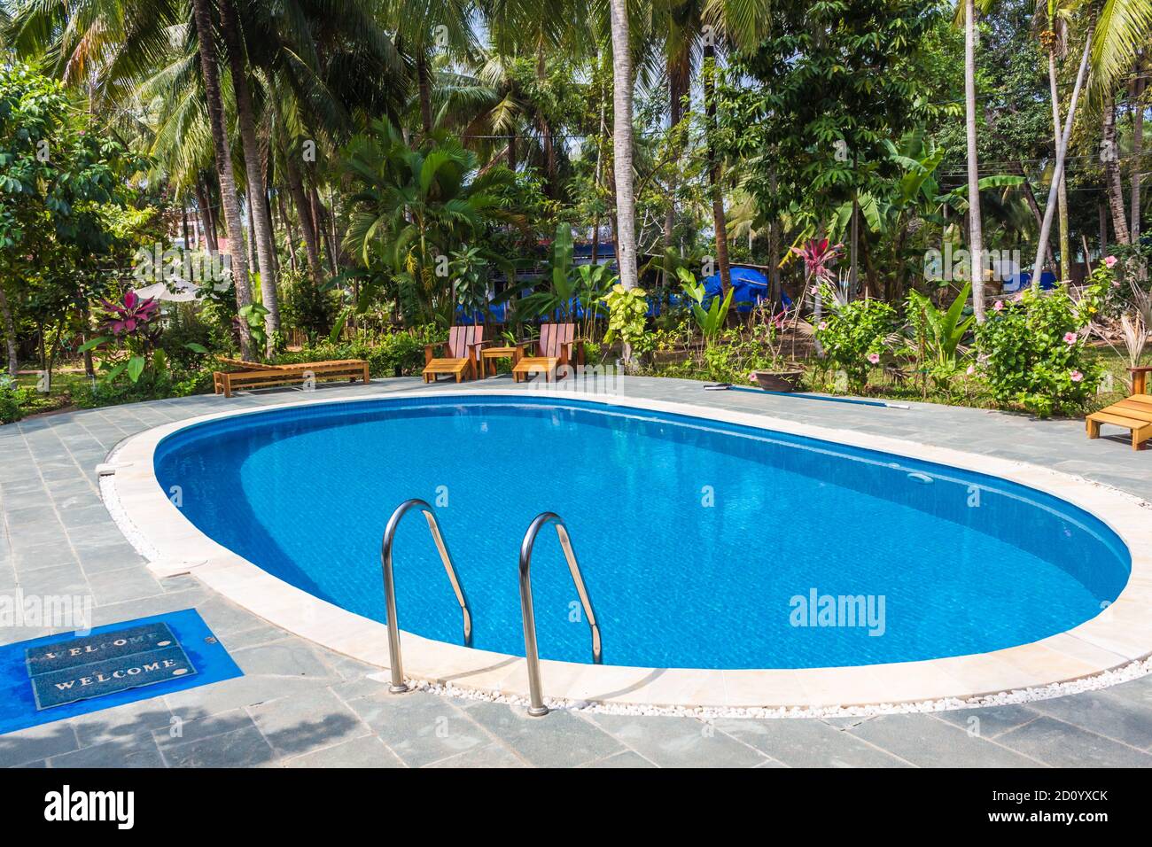 swimming pool in tropical resort with small garden Stock Photo - Alamy