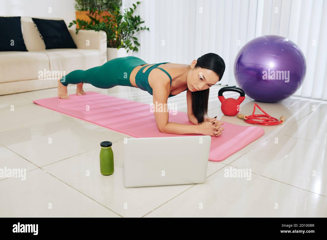Woman in plank position Stock Photo - Alamy