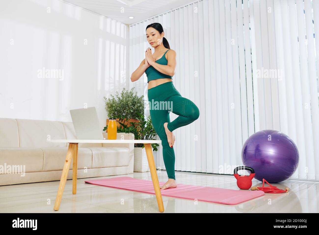 Woman following tree position Stock Photo - Alamy