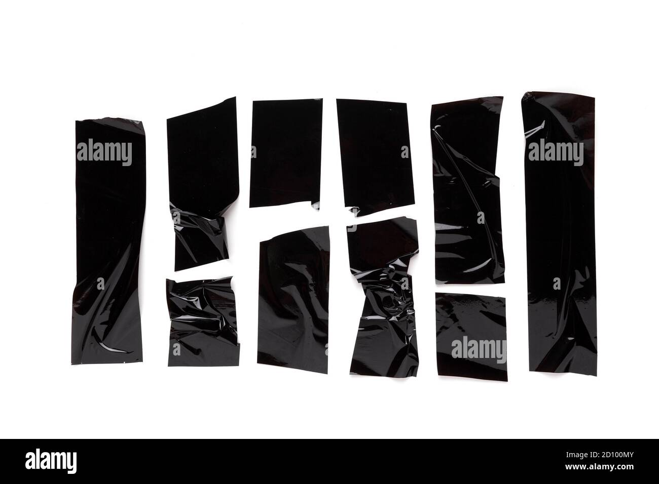 A collection of used black electrical tape pieces isolated on white ...