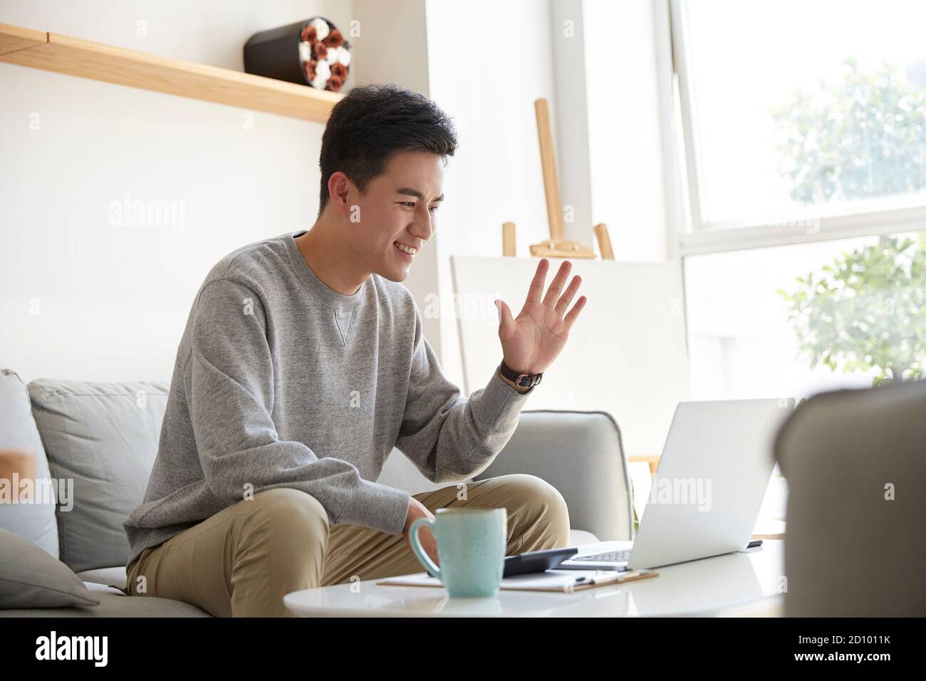 happy and smiling young asian corporate executive working from home ...