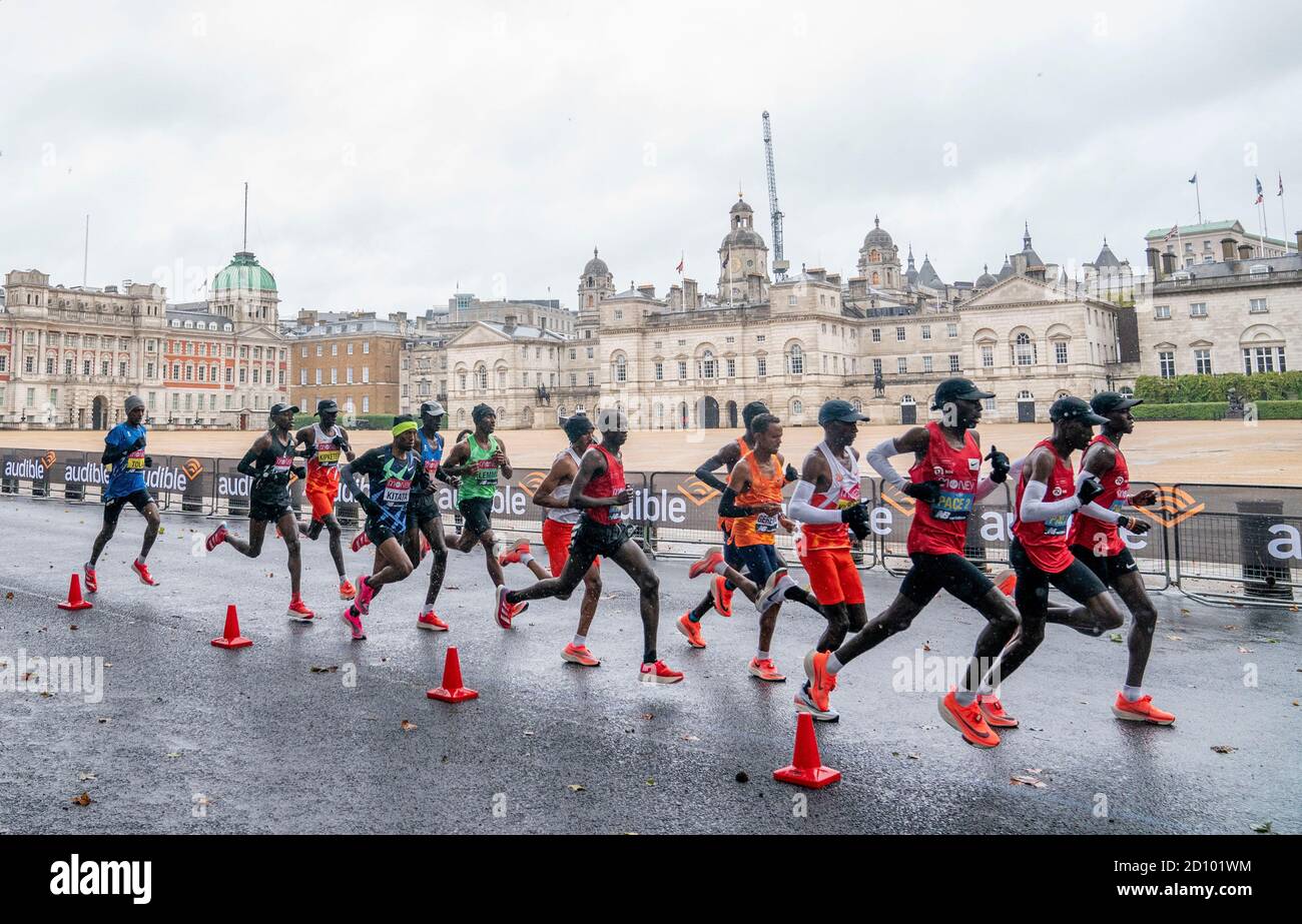 London, Britain. 4th Oct, 2020. Runners pass Horse Guards Parade during ...