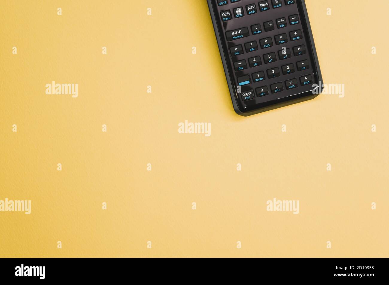 Top view of a scientific calculator on pastel yellow background with an ...