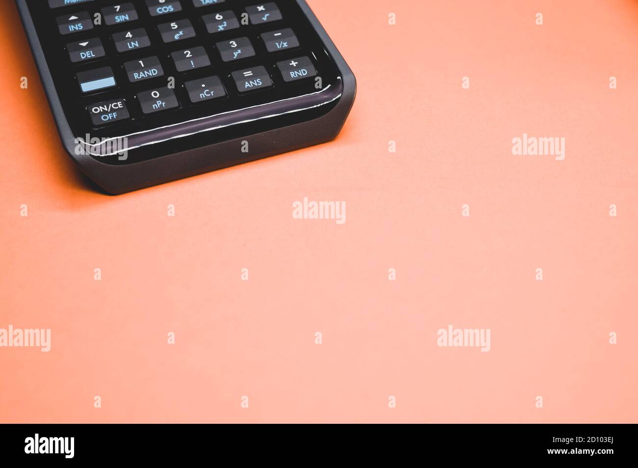 Scientific calculator on pastel peach background with an empty space ...