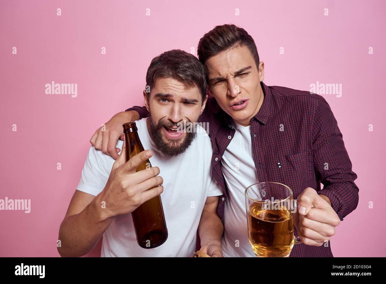 Two men drink beer friendship drunk alcohol lifestyle pink background ...