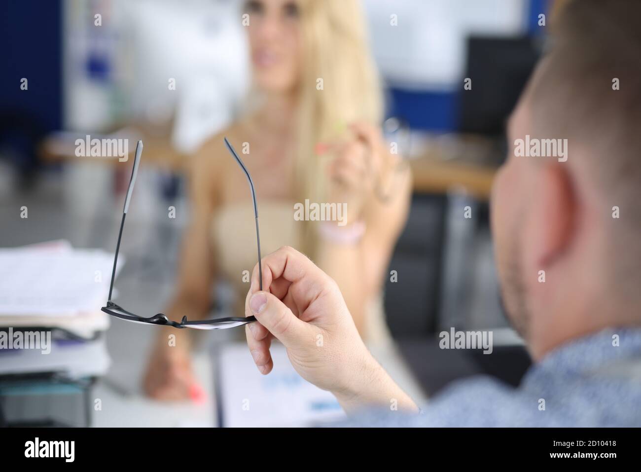 Man sit opposite woman face to face and hold glasses in his hand close ...