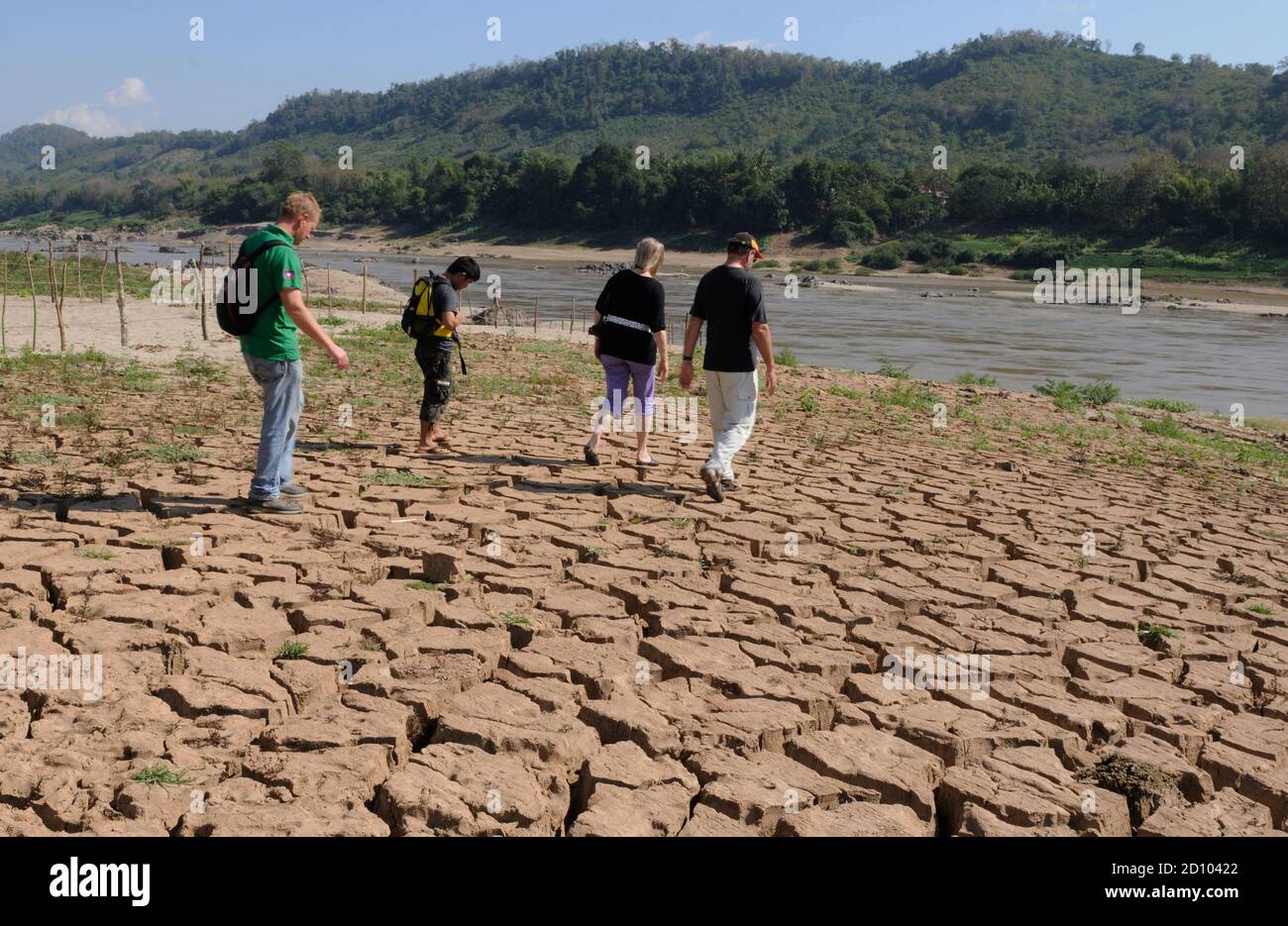 Mekong Sun cruise guests are walking over dry earth at the Mekong River ...