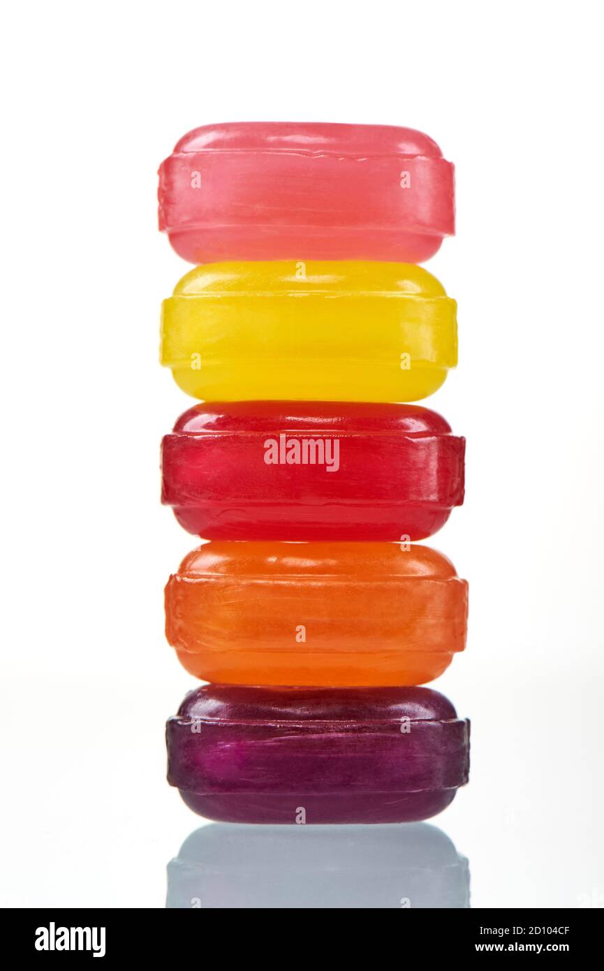 Stack colorful hard lollipop candies closeup on white background Stock ...