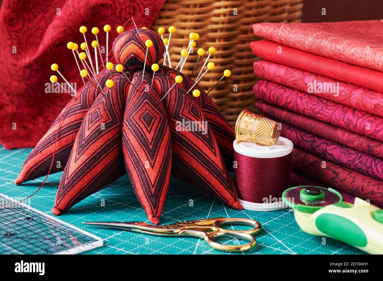 Set of red fabric and sewing tools on craft mat, close-up view Stock ...