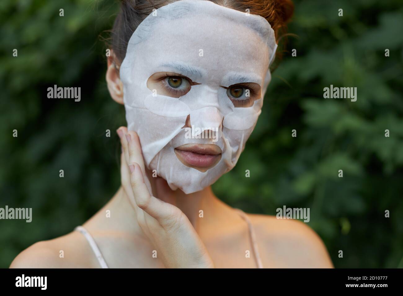 Portrait of a girl cosmetic mask Touch your face with your hand clear ...