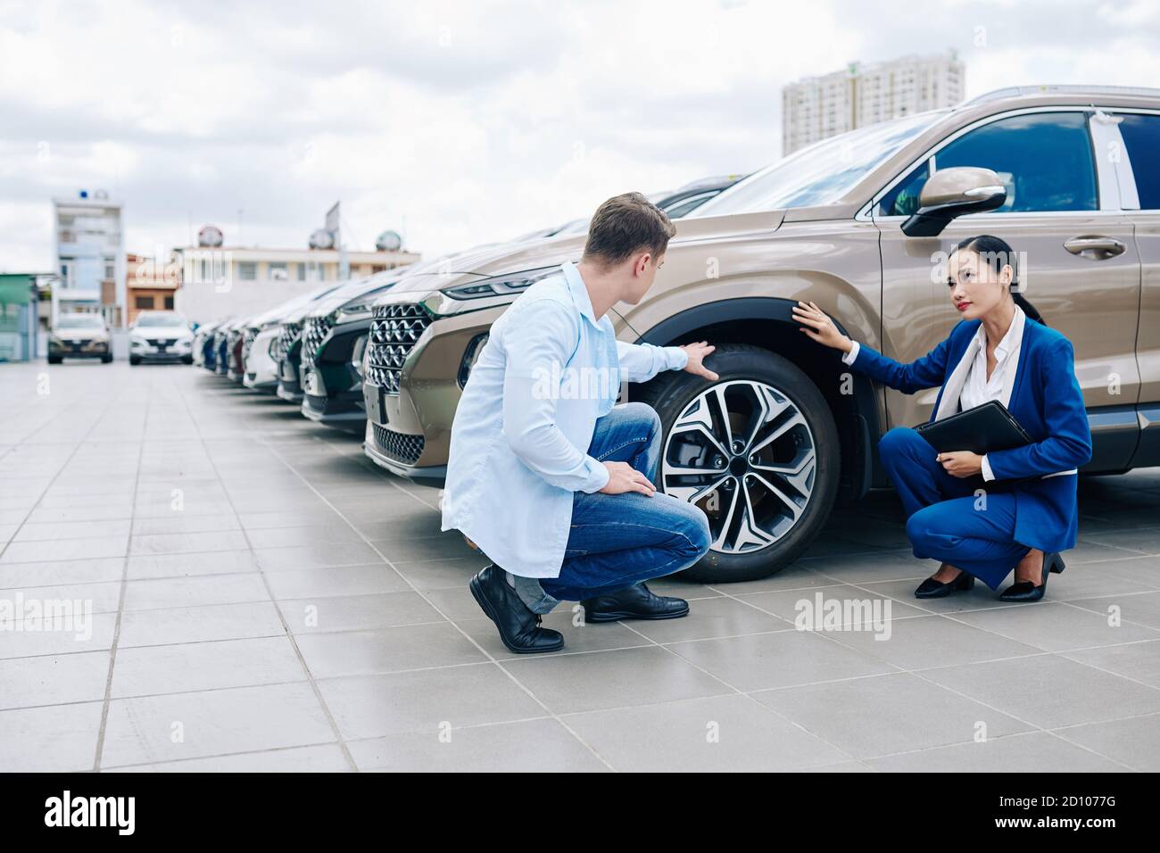 Cutomer checking car tires Stock Photo - Alamy