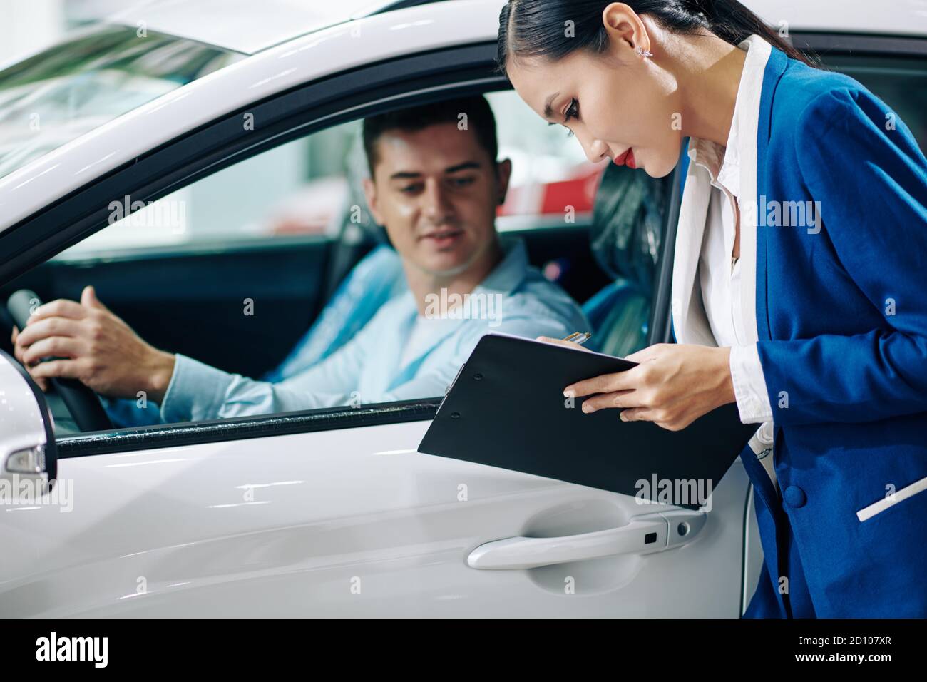Test drive in car dealership Stock Photo - Alamy