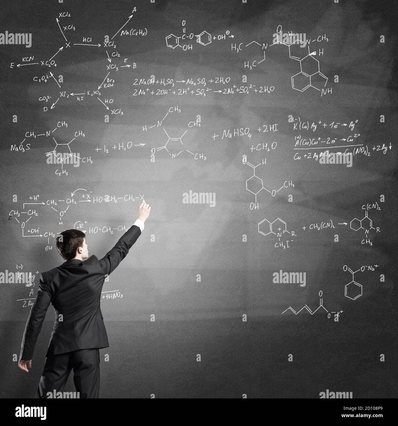 Scientist writing formulas on chalkboard Stock Photo - Alamy