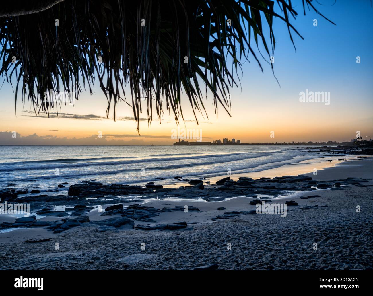 Fascinating sunset on a seashore seen through a thatch Stock Photo - Alamy