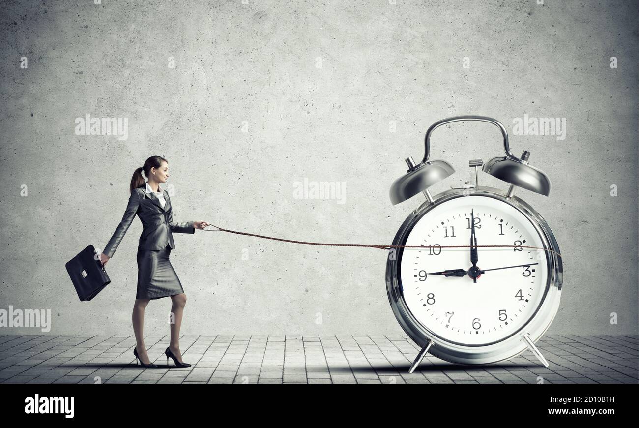 Woman controlling time Stock Photo - Alamy