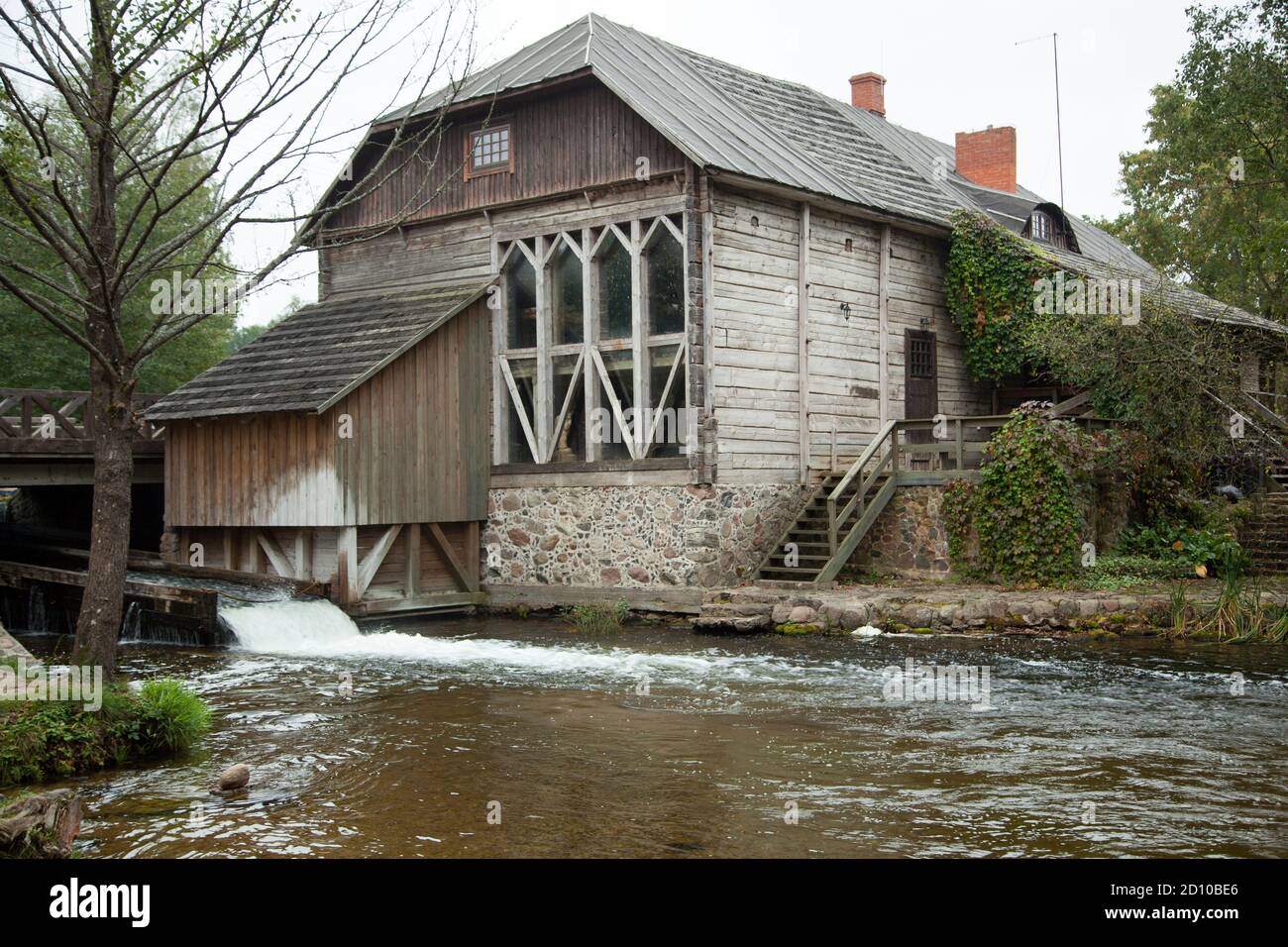 The historic 19th century Ginuciai town water mill in Autumn (Lithuania ...