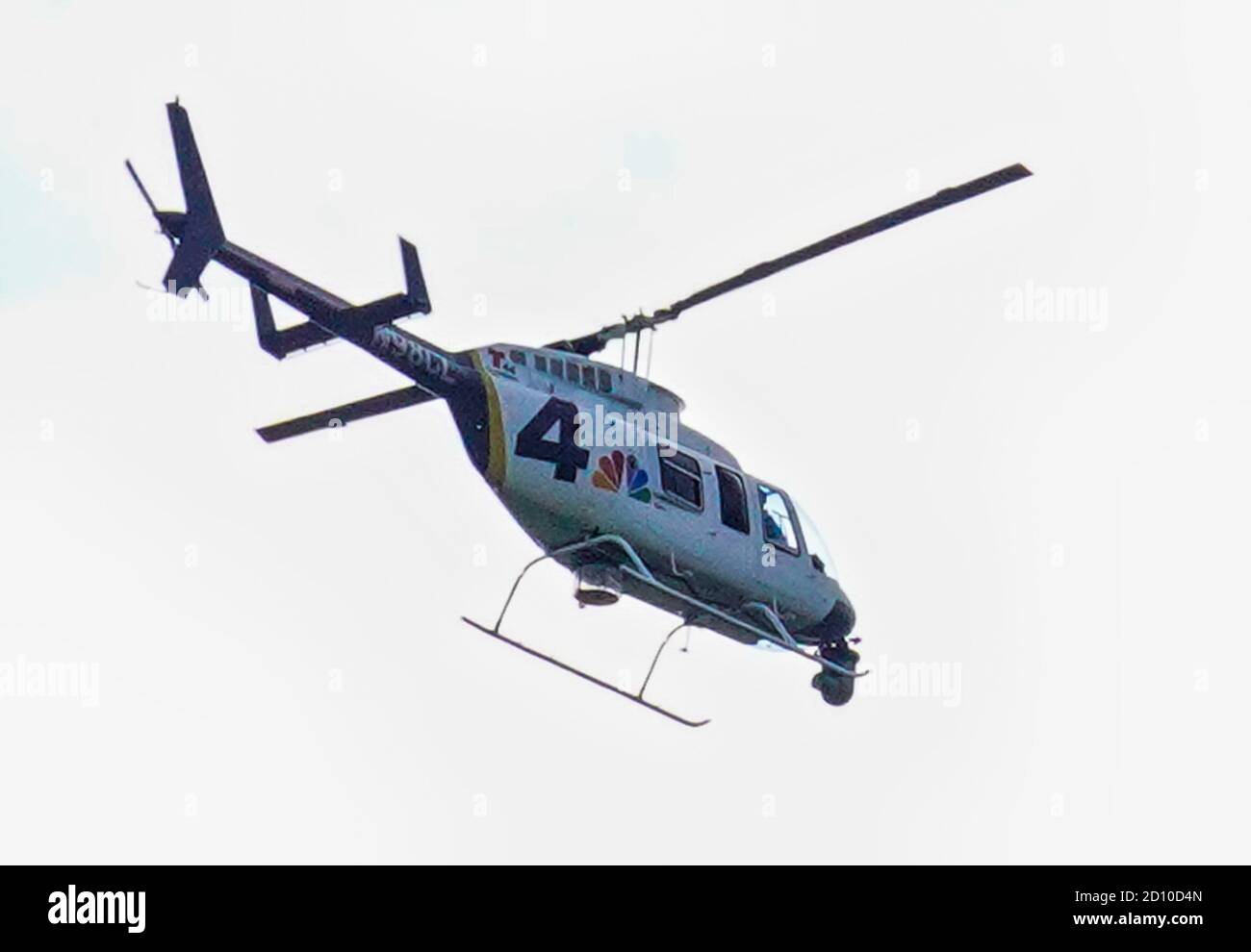 Local news channel helicopter in flight Stock Photo - Alamy