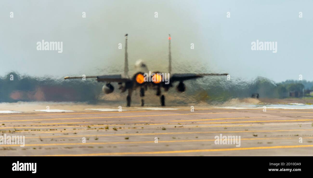 F-15E Strike Eagle, after burners lit, rolling down the runway at full ...
