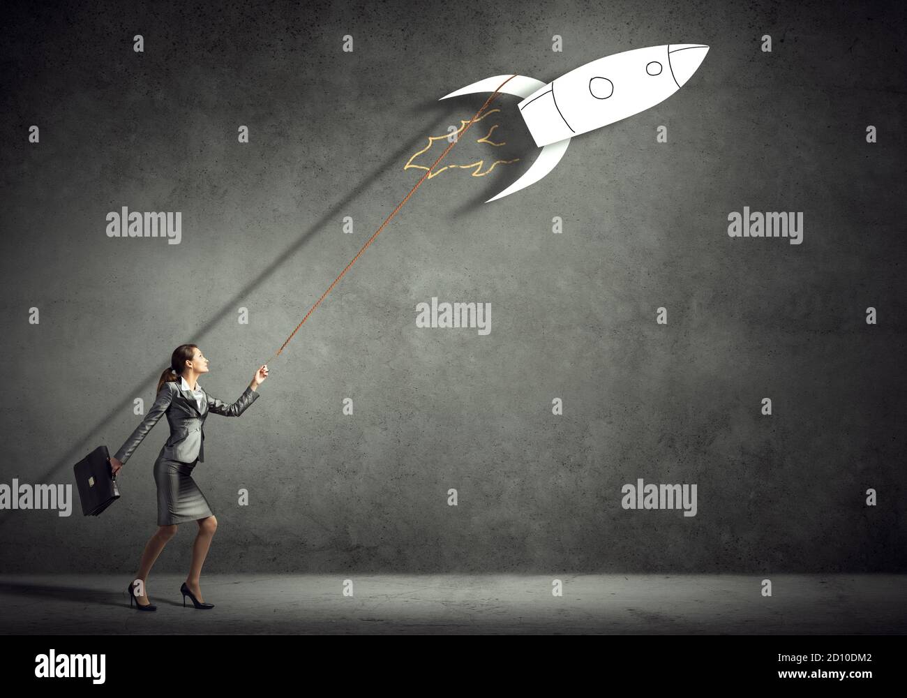 Woman catch rocket Stock Photo - Alamy