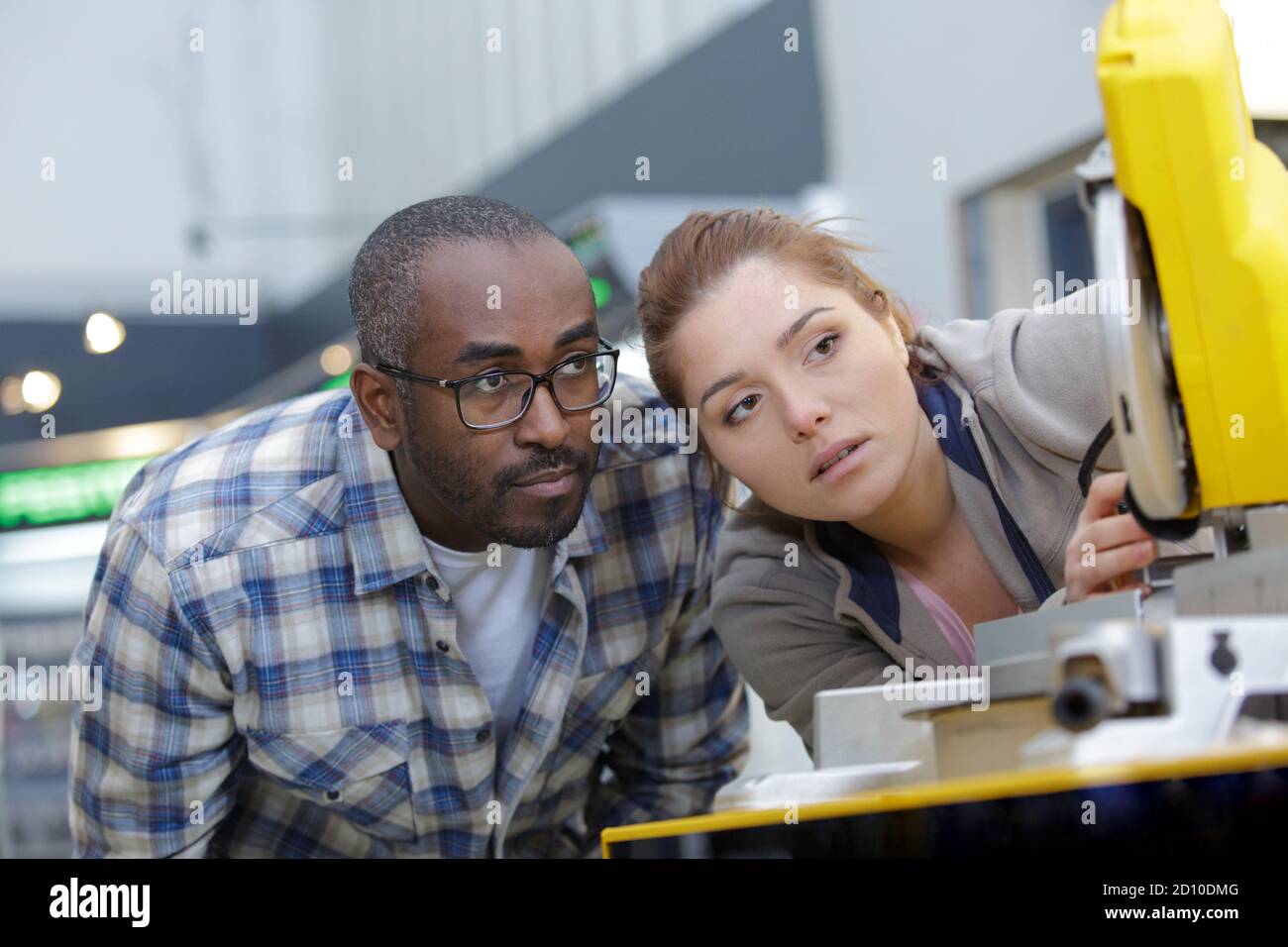 technicians checking a tool in a factory Stock Photo - Alamy