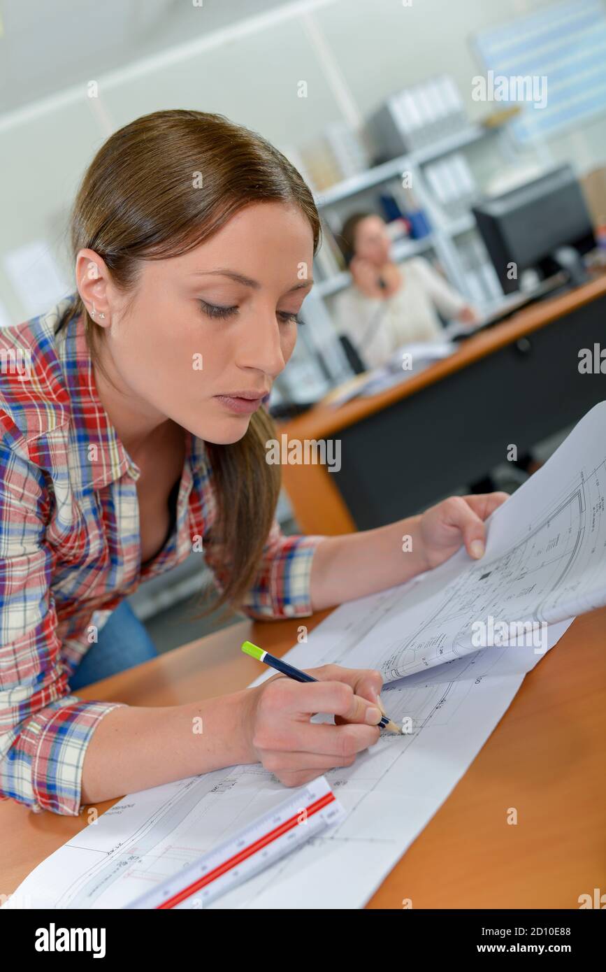 female worker is drawing plans Stock Photo - Alamy
