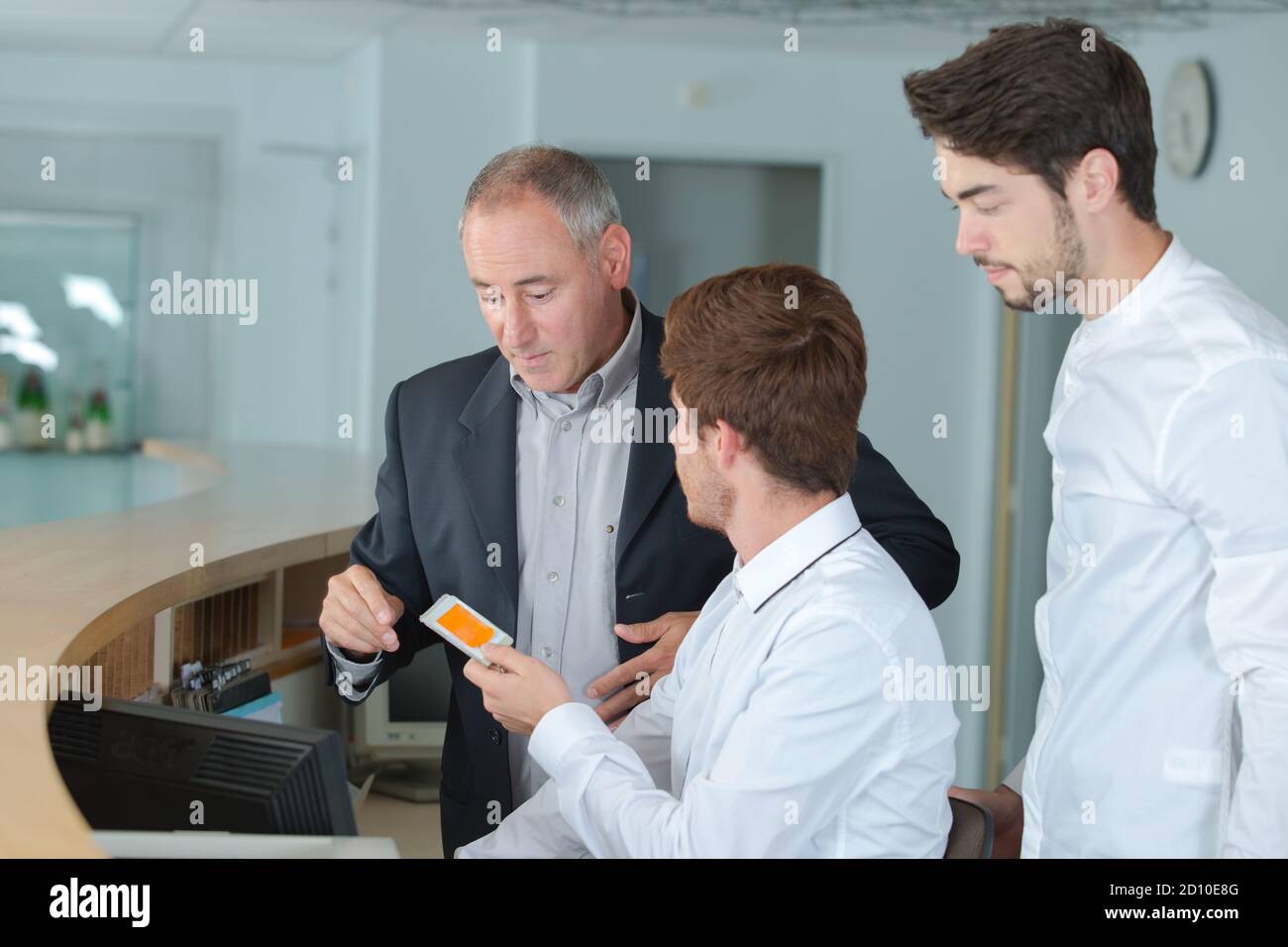 man in hotel check in at reception or front office Stock Photo - Alamy