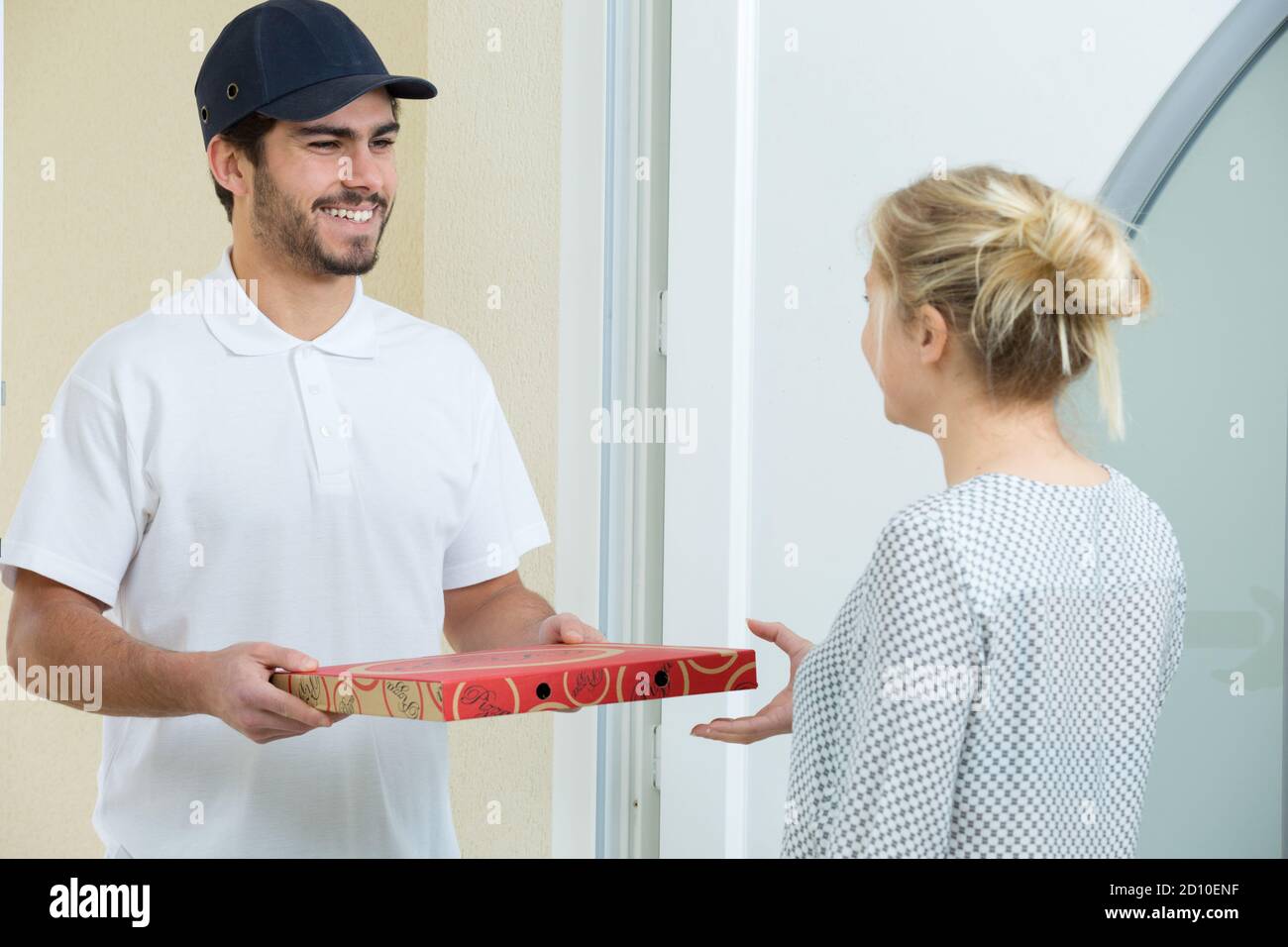 Woman welcoming man into the house hi-res stock photography and images ...