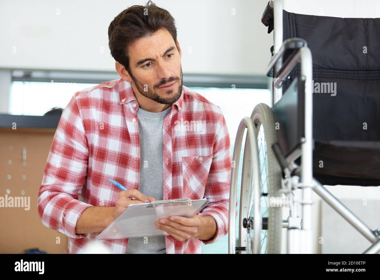 male mechanic maintaining a wheelchair Stock Photo - Alamy