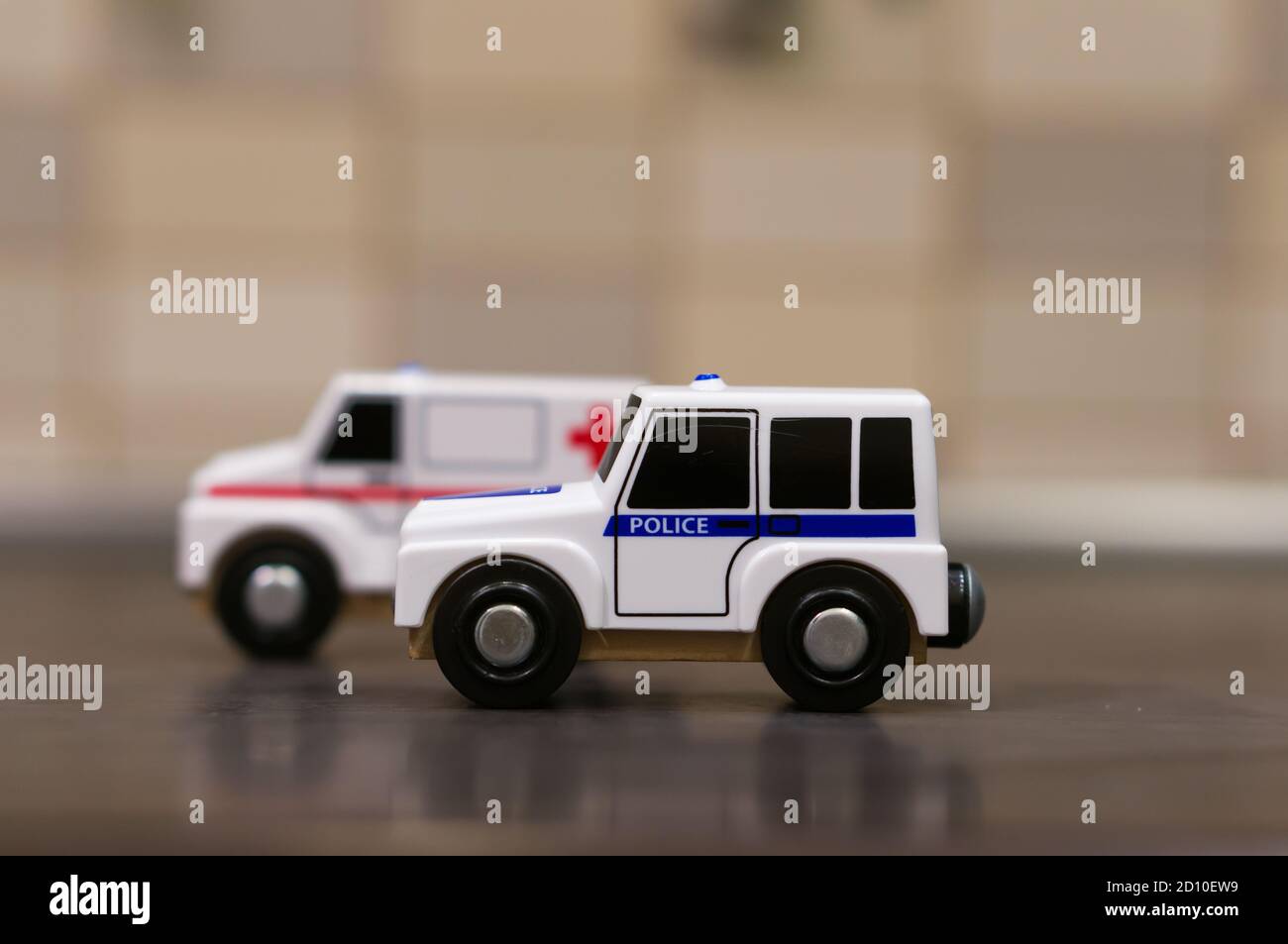 Closeup of toy medical cars on a reflective surface Stock Photo - Alamy