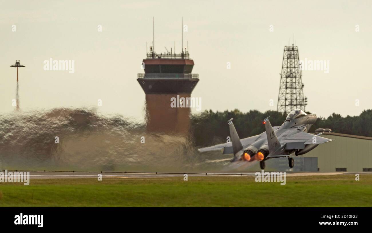 F-15E Strike Eagle, after burners lit, rolling down the runway at full ...