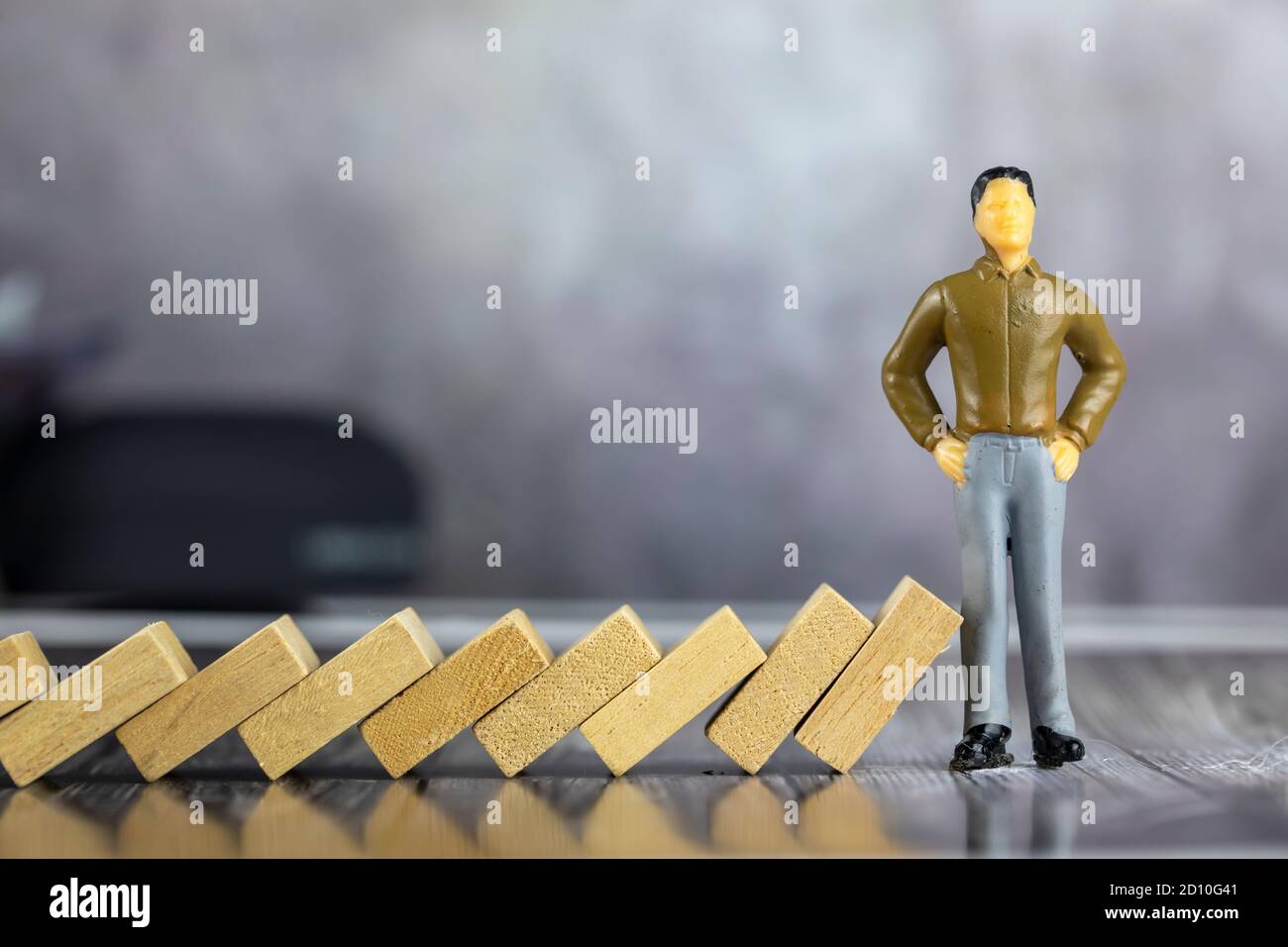 Businessman and stops domino. Risk management concept Stock Photo - Alamy